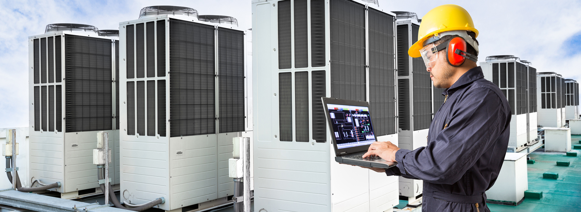 Electrical engineer using laptop computer for maintenance air co ...